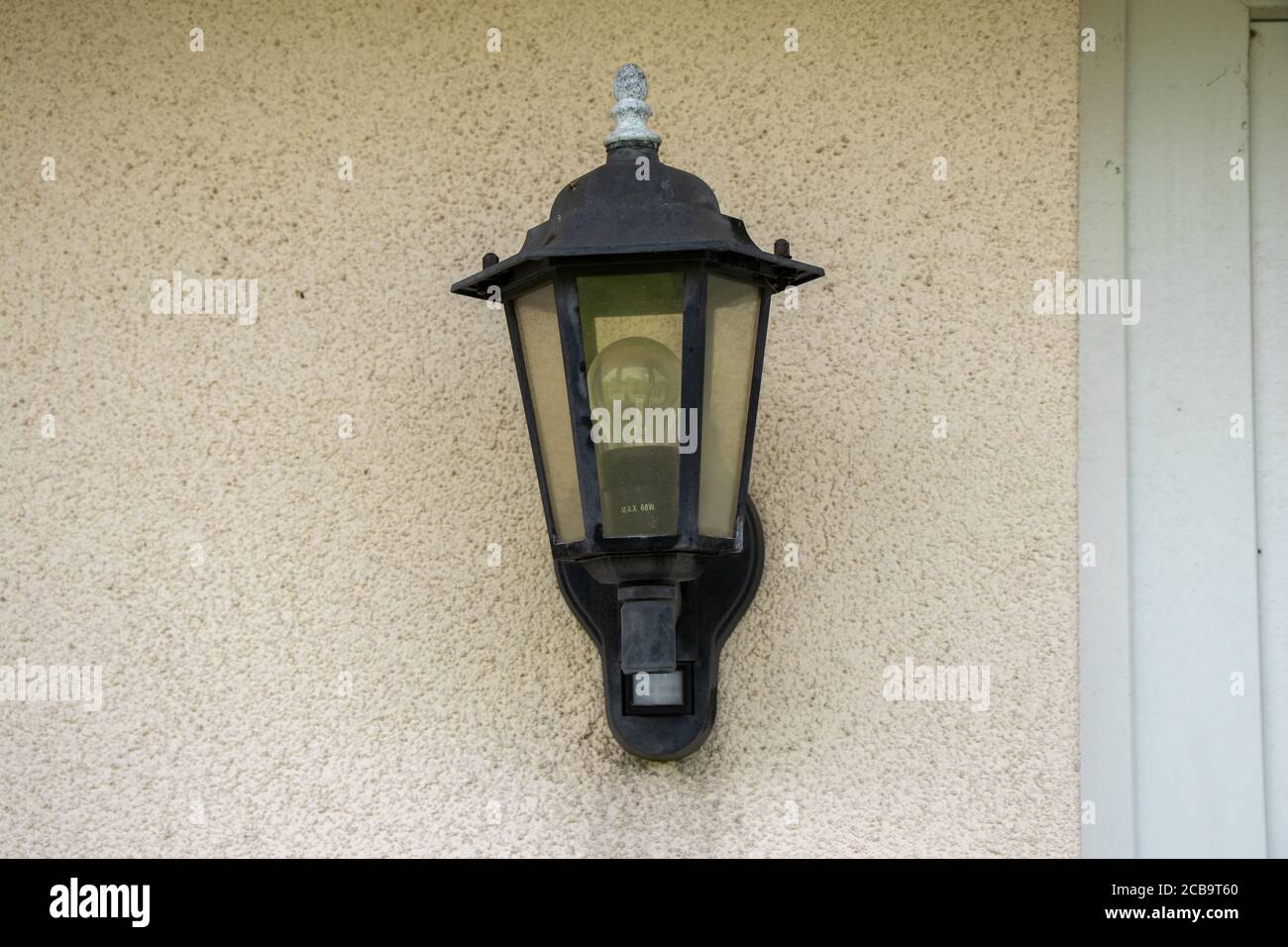 Black wall-mounted lamp covered with dust Stock Photo - Alamy