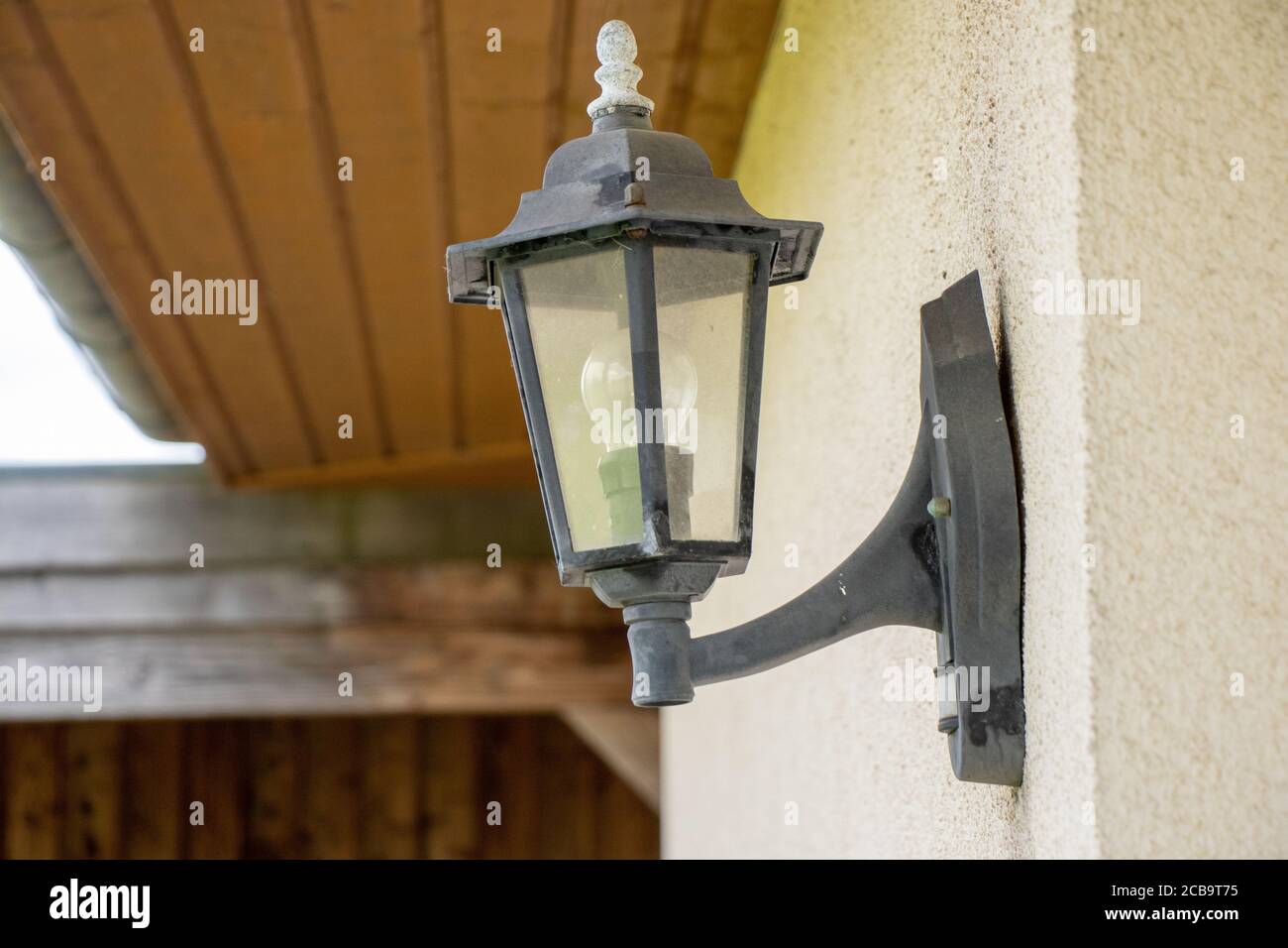 Wall-mounted lamp covered with dust Stock Photo - Alamy