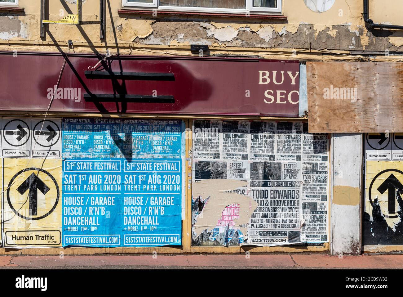 Closed business plastered with advertising posters for events, which ...