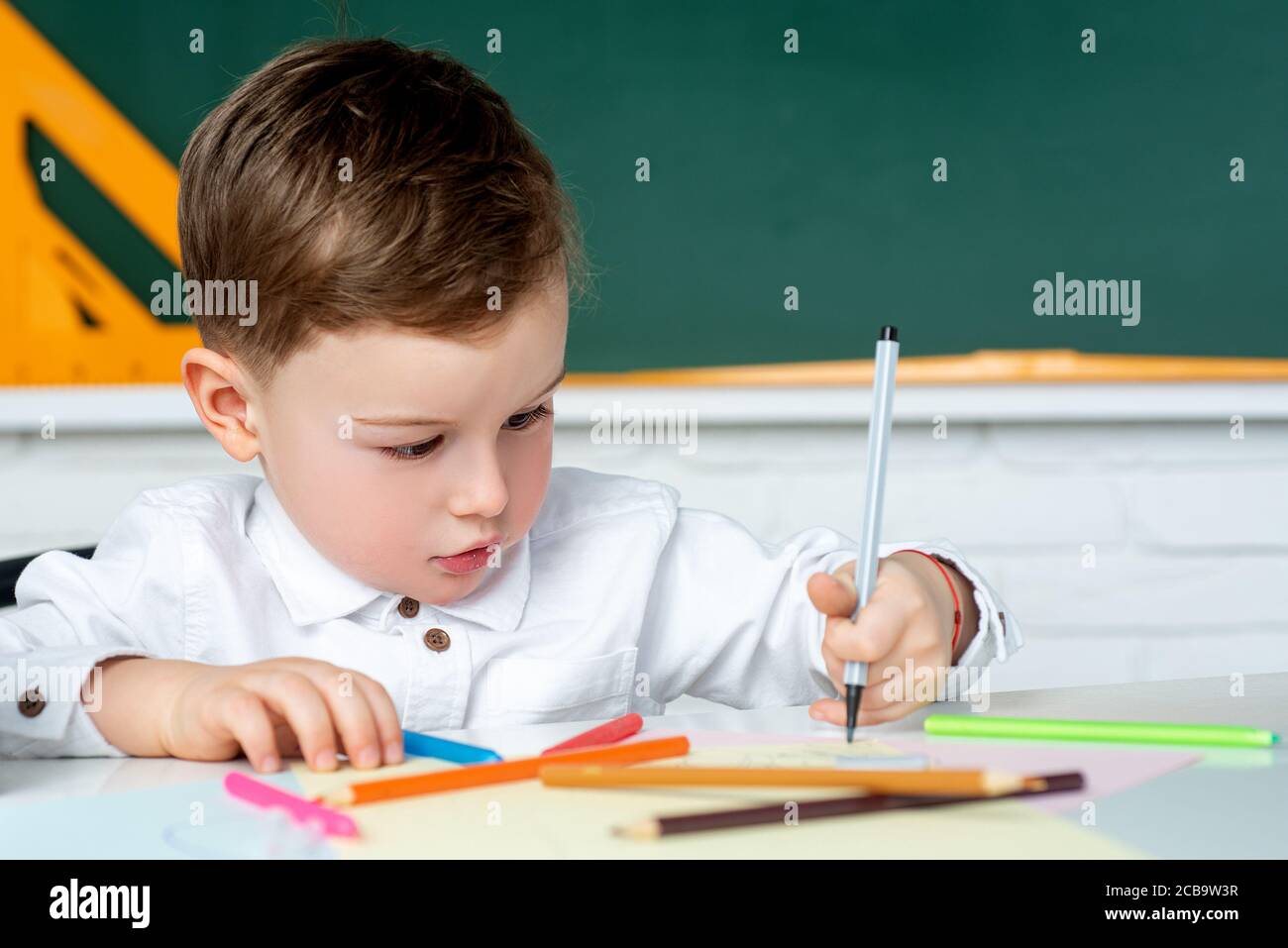 Kid drawing on paper. Children home learning. Child from elementary ...