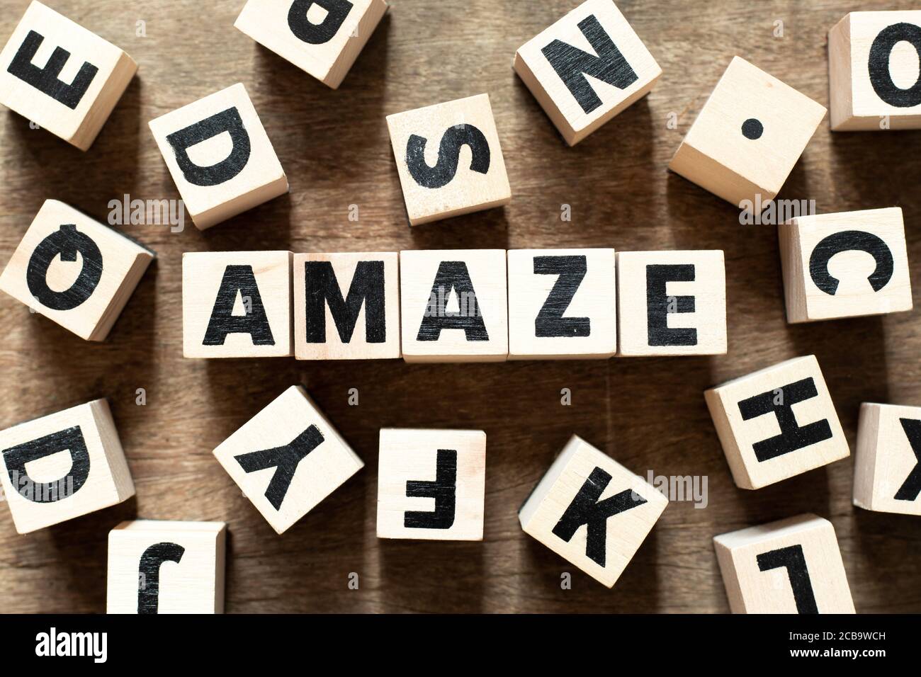 Wood letter block in word amaze on wood background with another ...