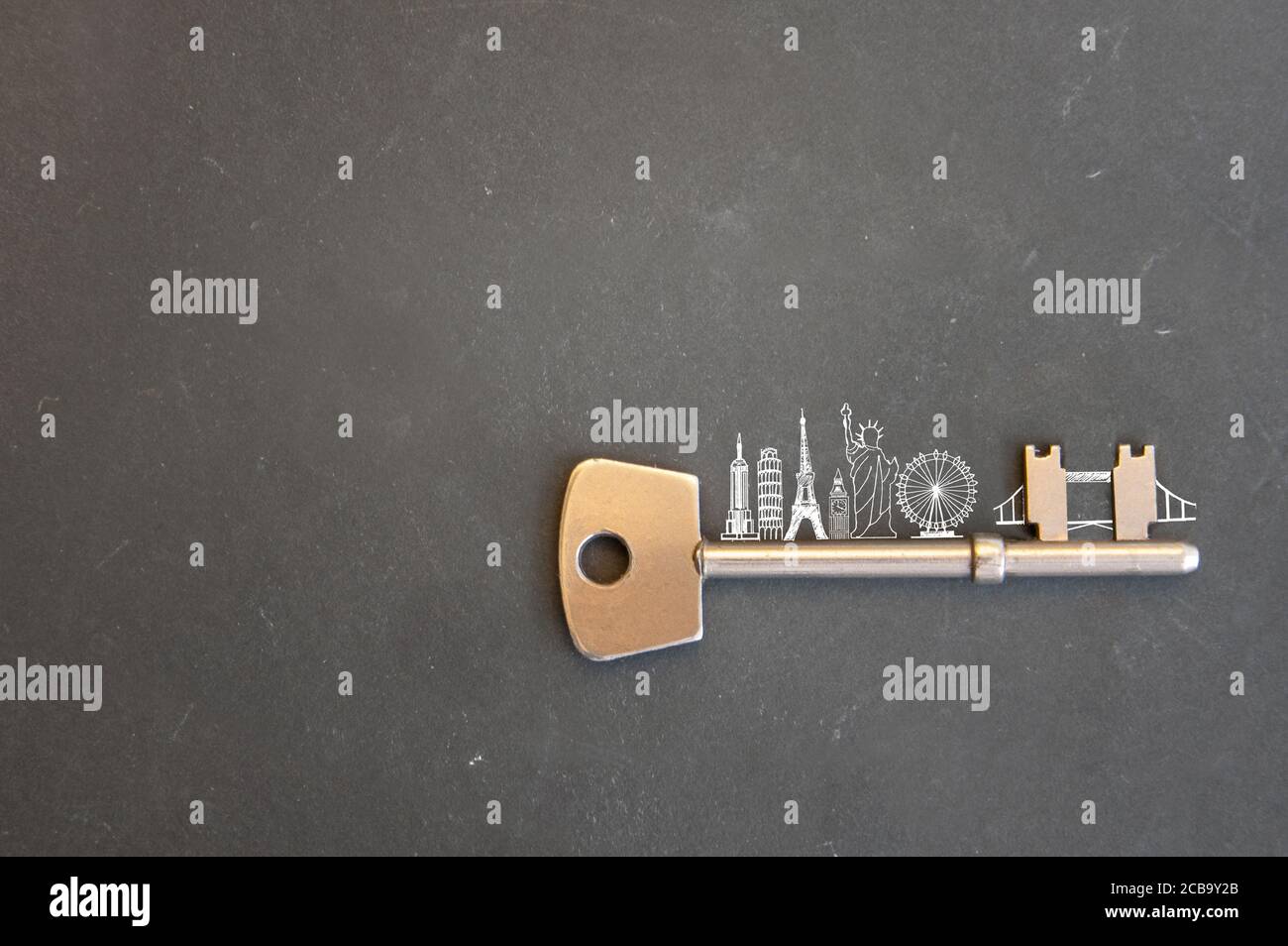 Gold key with skyline sketch of global landmarks Stock Photo - Alamy