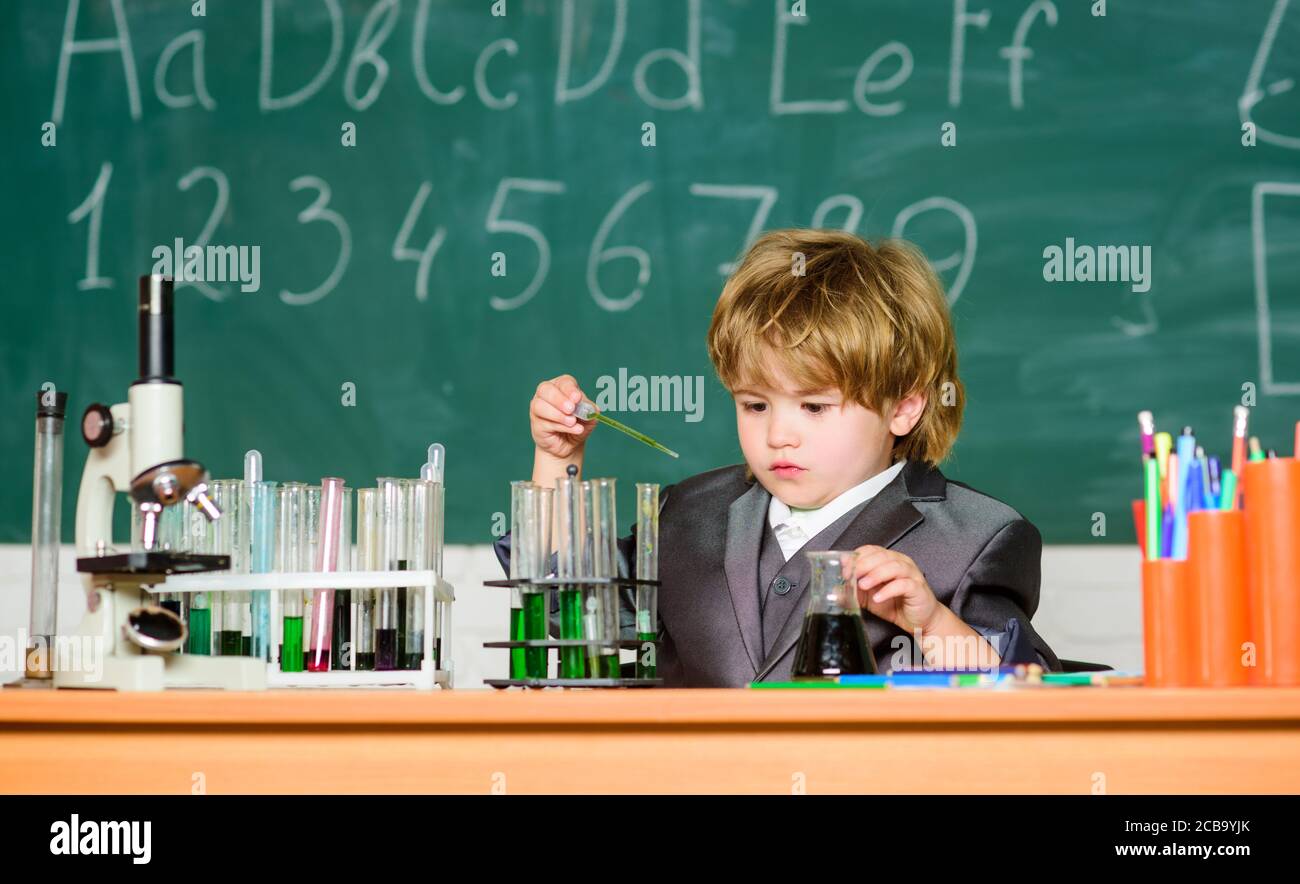 chemistry lab. Back to school. Little boy at chemical cabinet. Little ...