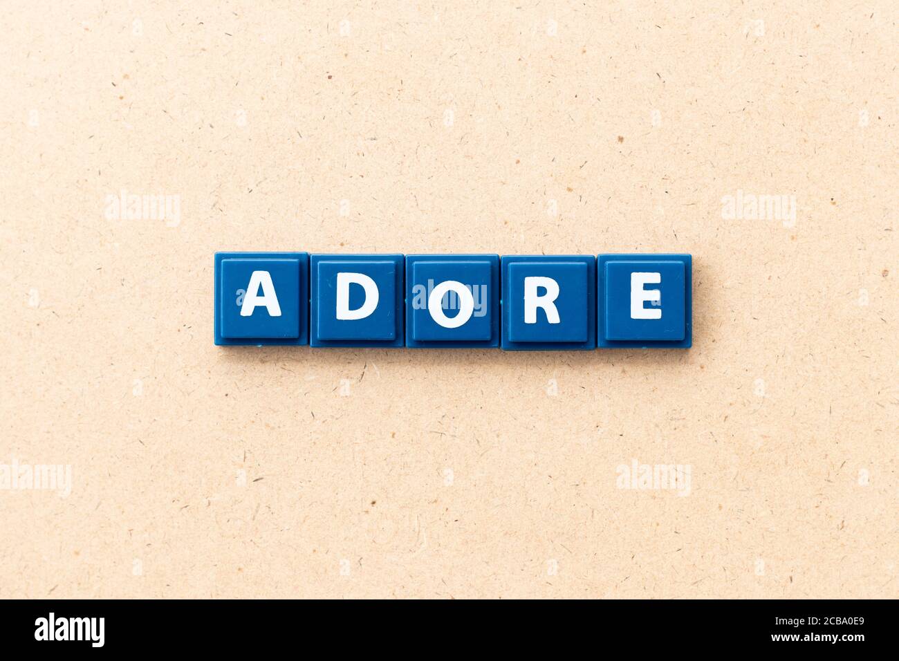 Tile letter in word adore on wood background Stock Photo - Alamy