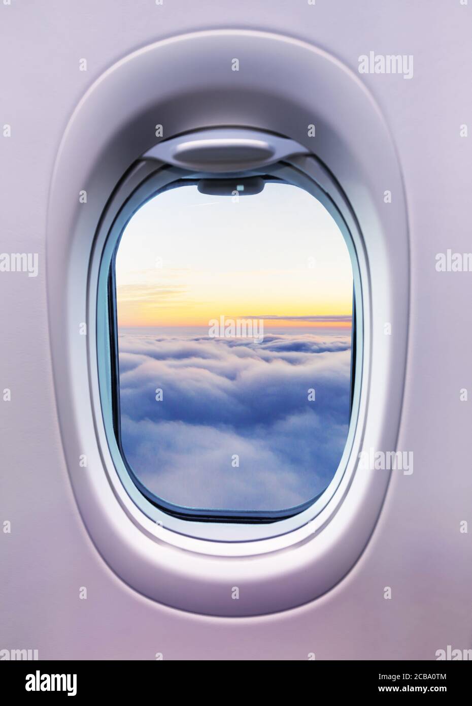 Airplane interior with window view of sunset above clouds. Concept of ...