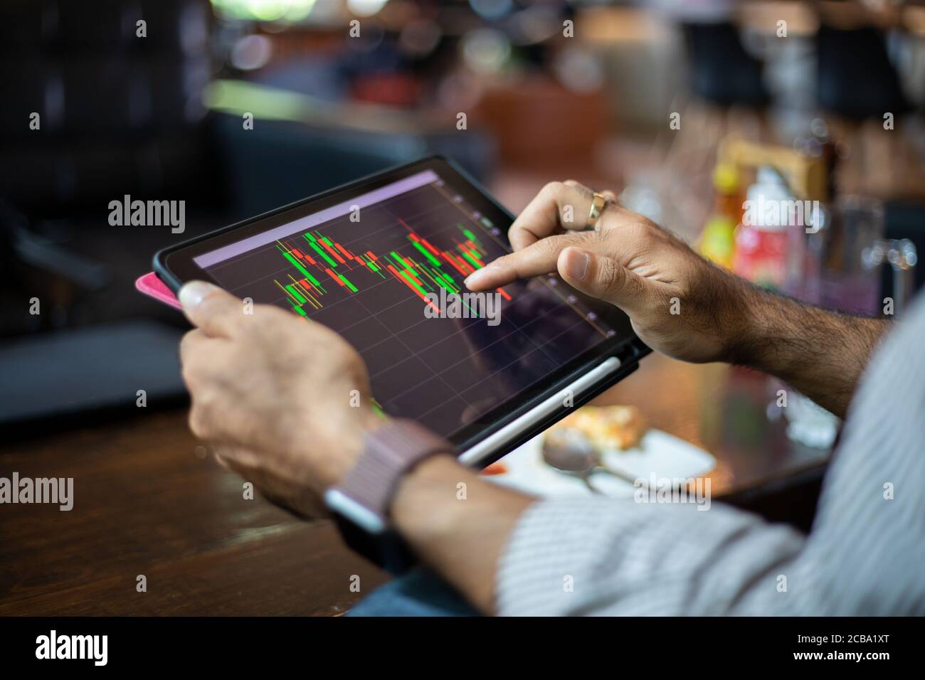 Asian business men using a tablet for working and checking stock trends ...