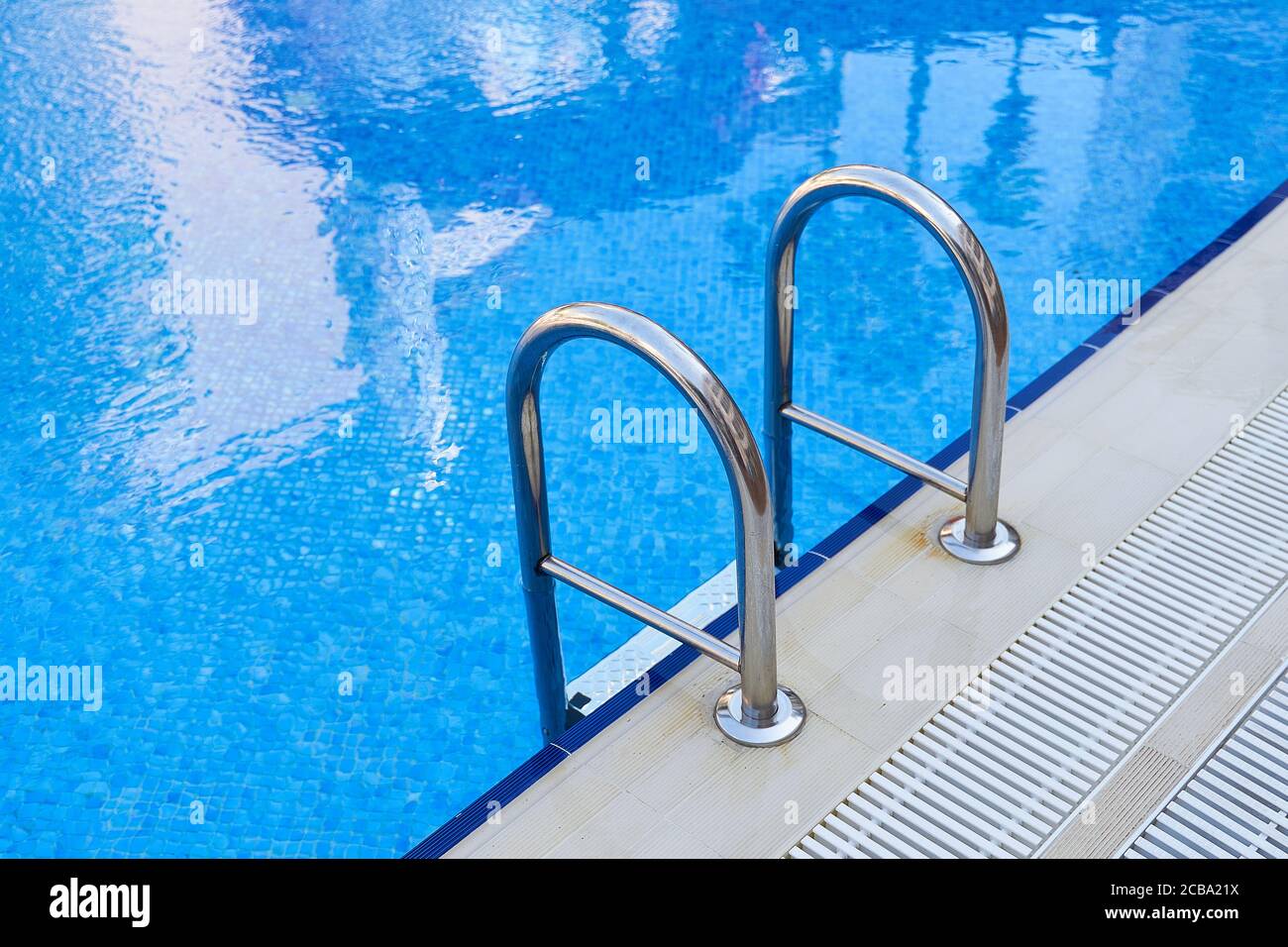 Empty swimming pool with metal ladder. Closed hotels. Private pool at ...