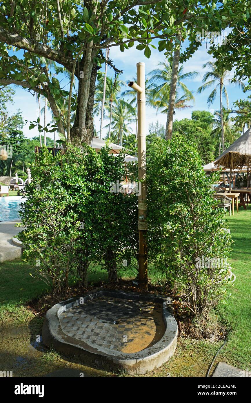 Tropical outdoor poolside showers by the swimming pool Stock Photo - Alamy