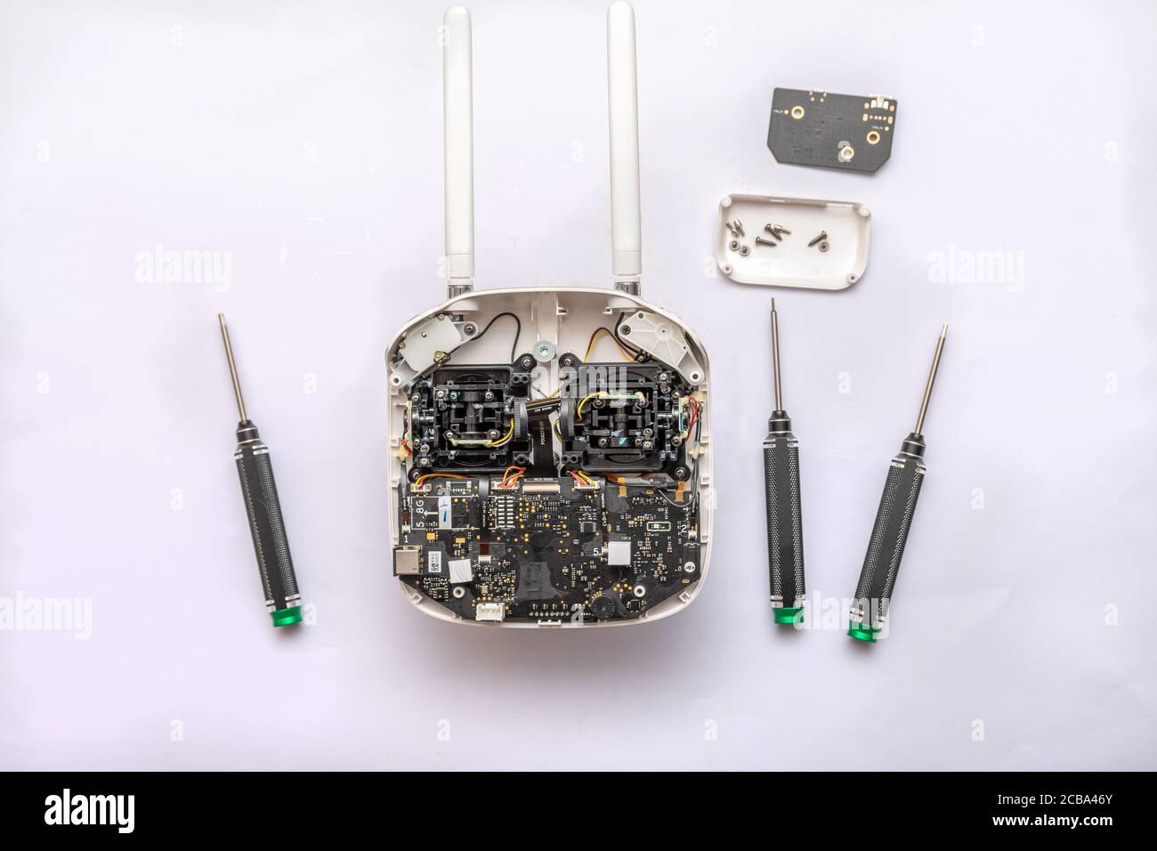 Top view of an open wifi router with tools isolated on a white ...