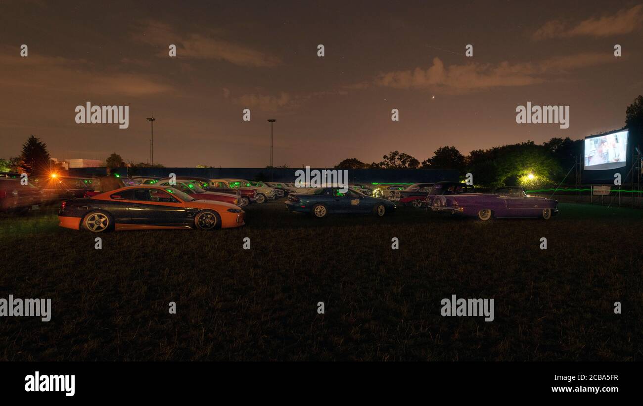Cars at a drive in movie at night Stock Photo - Alamy