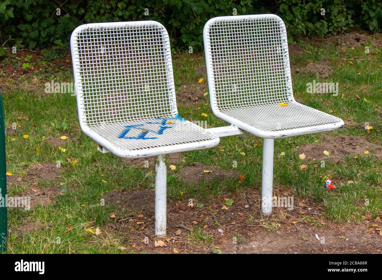 High angle shot of white metal chairs in the garden Stock Photo - Alamy