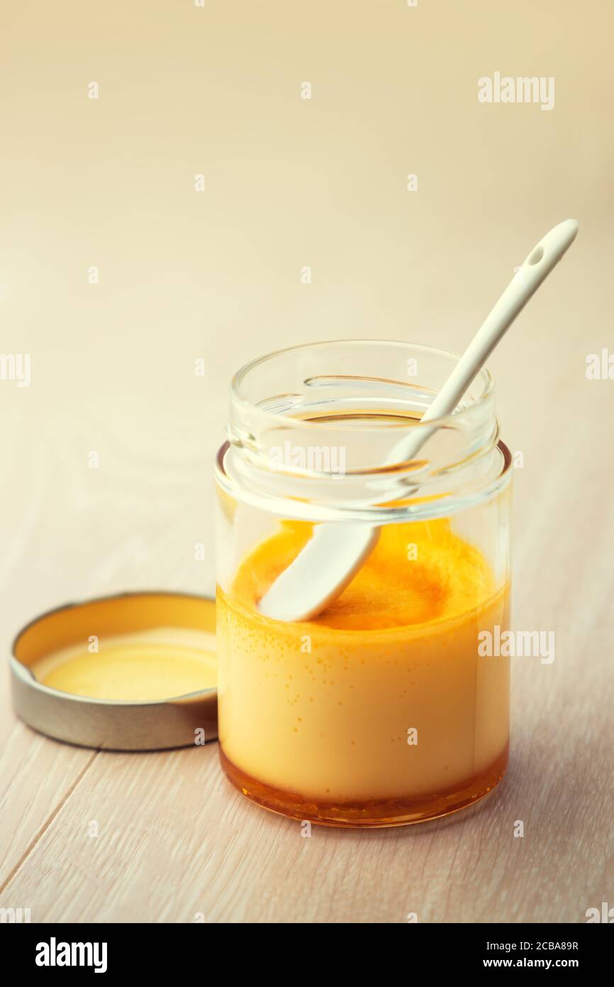 Cream caramel in a jar isolated on wooden background Stock Photo - Alamy