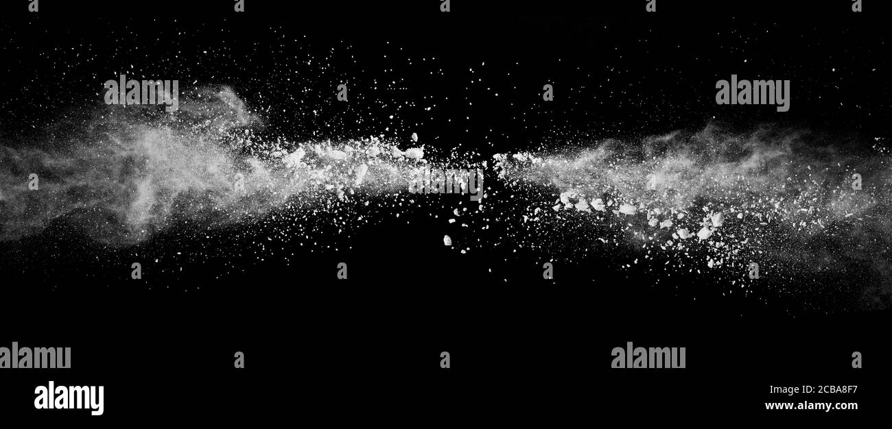 Abstract white powder explosion isolated on black background. High ...