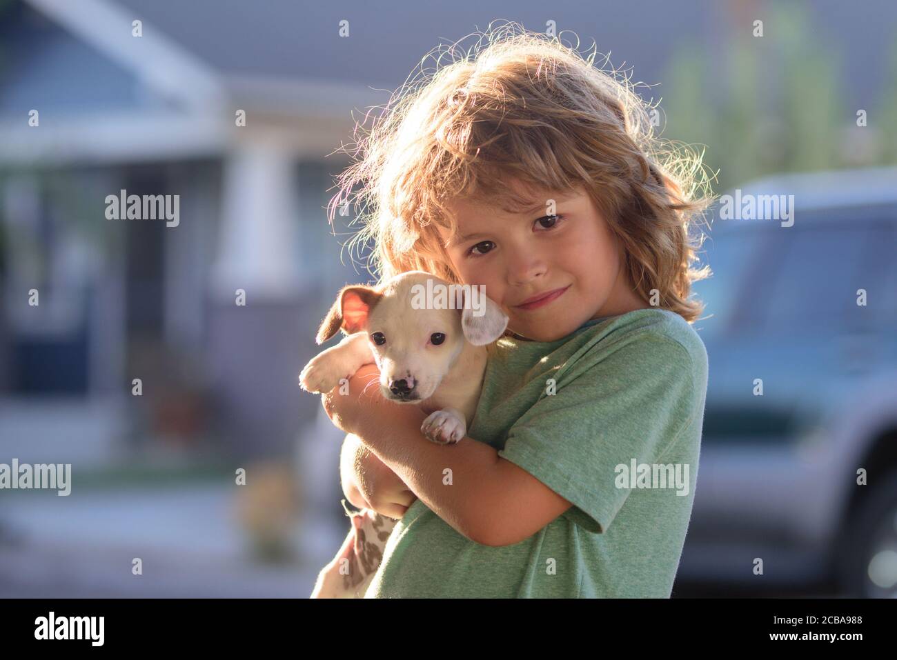 Little boy hugging a dog. Happy child and dog hugs her with tenderness ...
