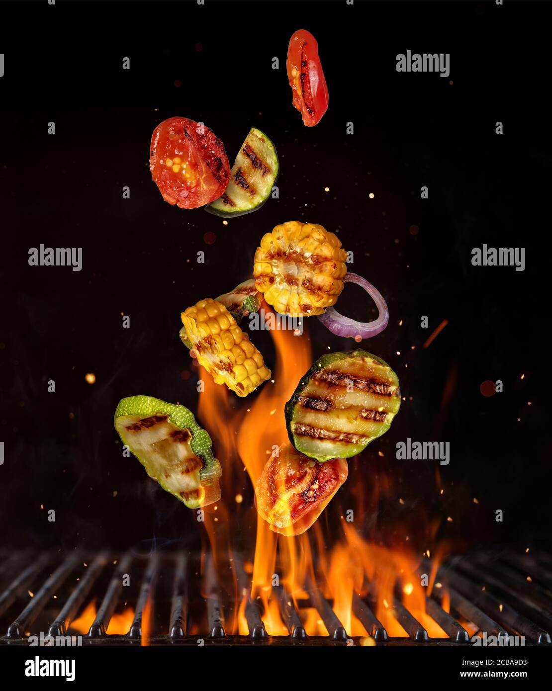 Flying pieces of vegetable from grill grid, isolated on black ...