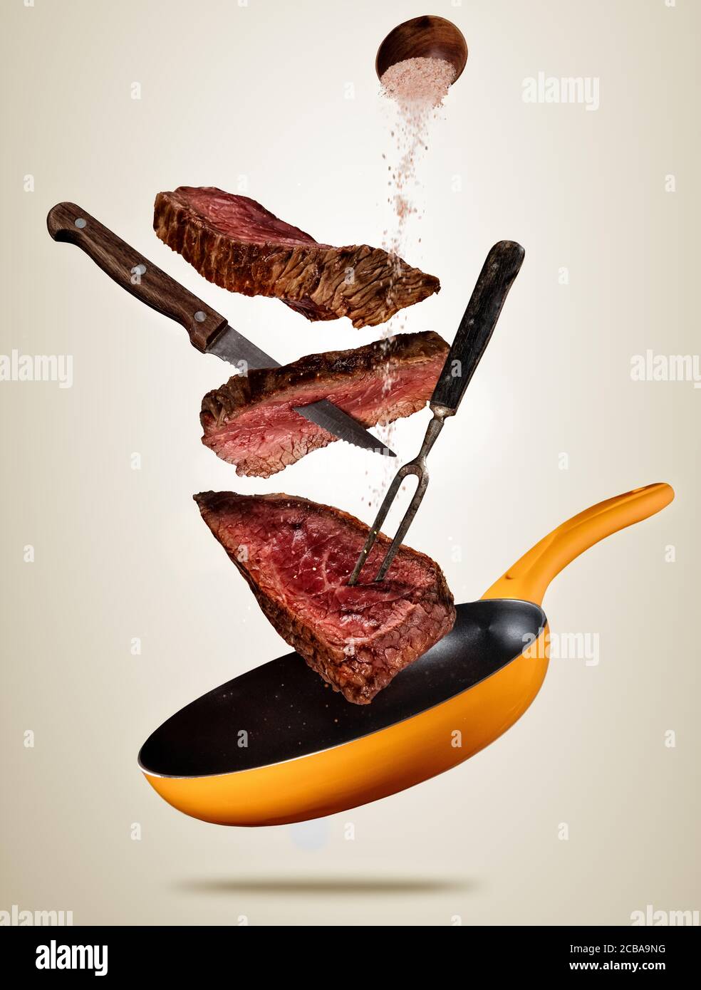 Flying pieces of beef steaks from pan, isolated on colored background ...