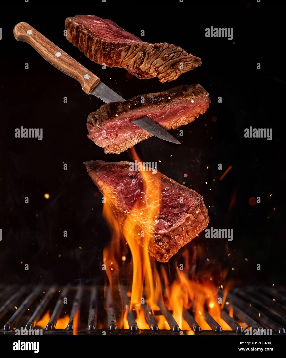 Flying pieces of beef steaks from grill grid, isolated on black ...