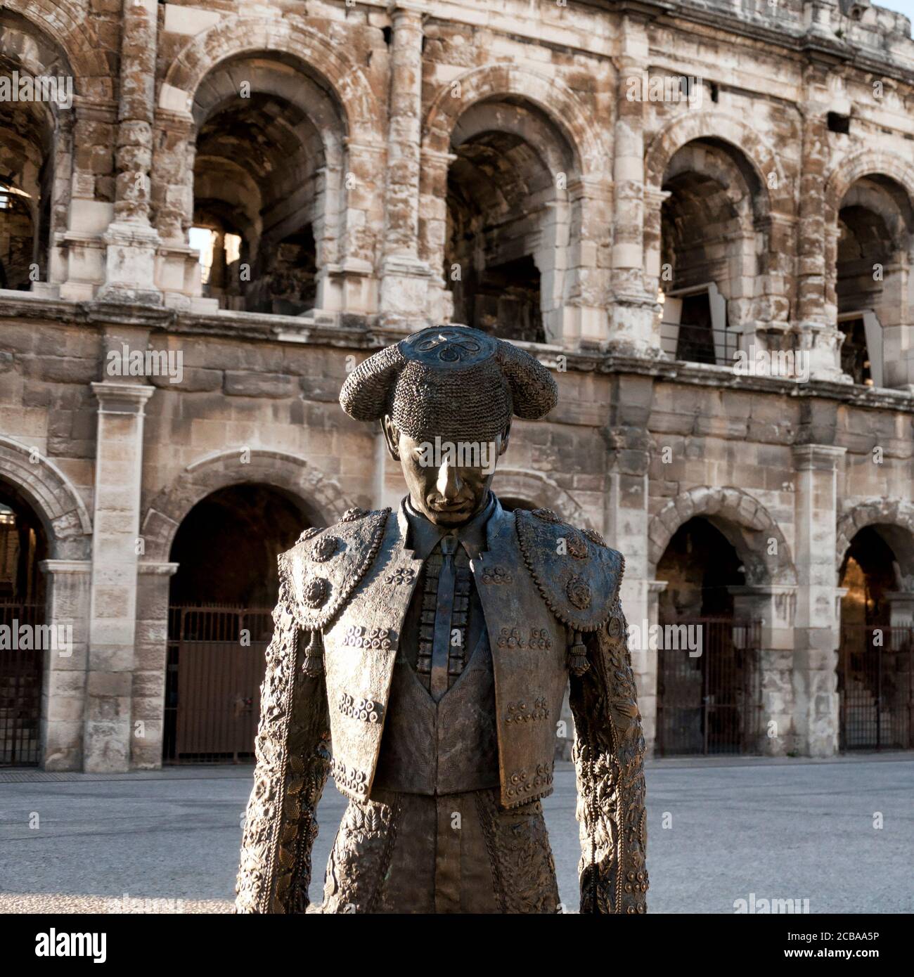 Bullfighter statue, in the background the elliptical Roman amphitheatre ...