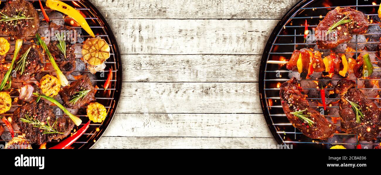 Top view of fresh meat and vegetable on grill placed on wooden floor ...