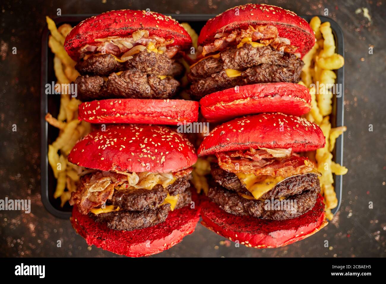 Burgers placed on french fries Stock Photo - Alamy