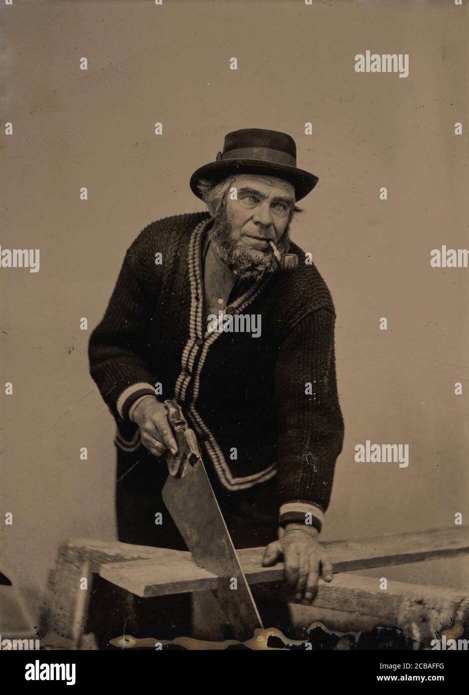 Carpenter Sawing a Plank of Wood, 1880s-90s Stock Photo - Alamy
