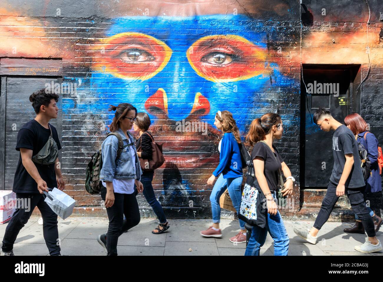 People walk past a Dale Grimshaw public work painting in Hanbury Street ...