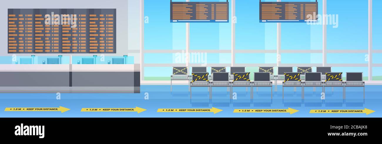 airport terminal with signs for social distancing yellow stickers ...
