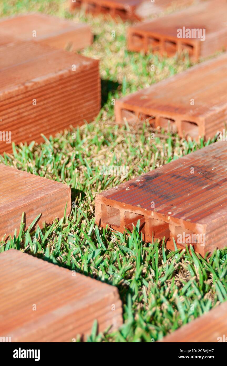 Bricks aligned over the grass Stock Photo - Alamy