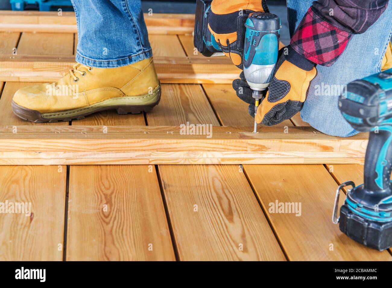 Caucasian Worker Assembling Wood Boards Using Cordless Drill Driver to ...