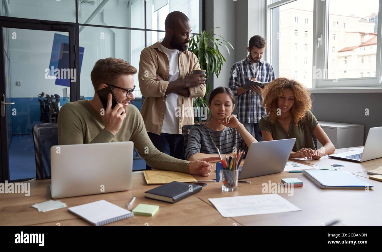 Business people at work. Group of multiracial coworkers communicating ...