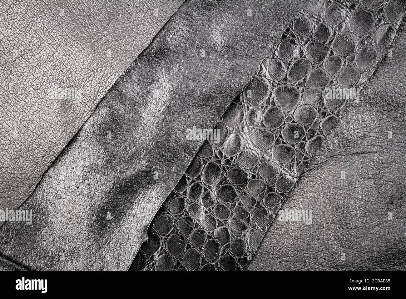 Black leather and fake artificial alligator skin textures background ...