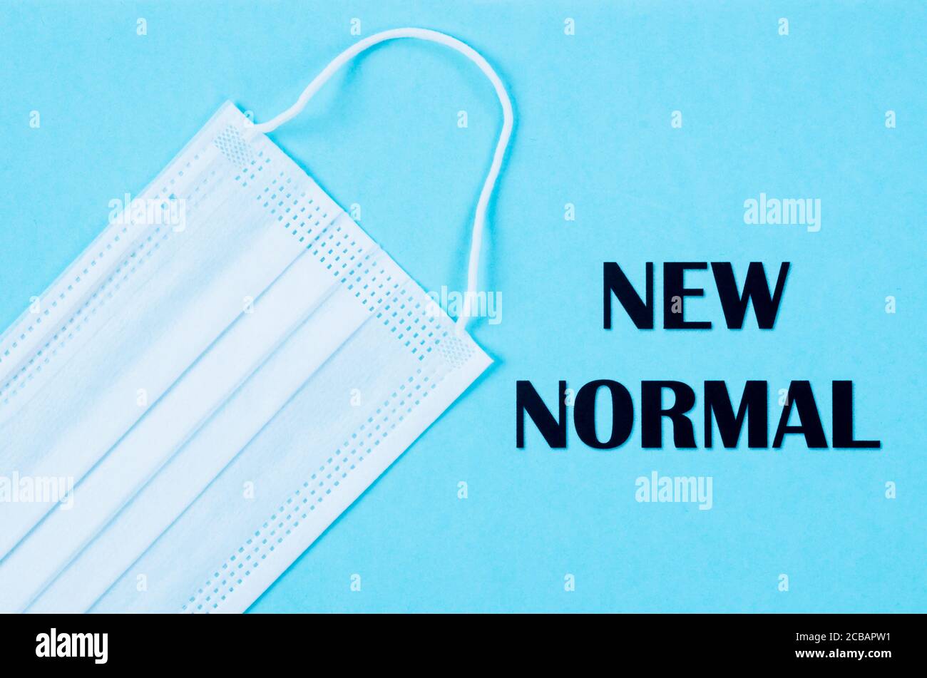 NEW NORMAL word with surgical medical face mask. Life after pandemic ...