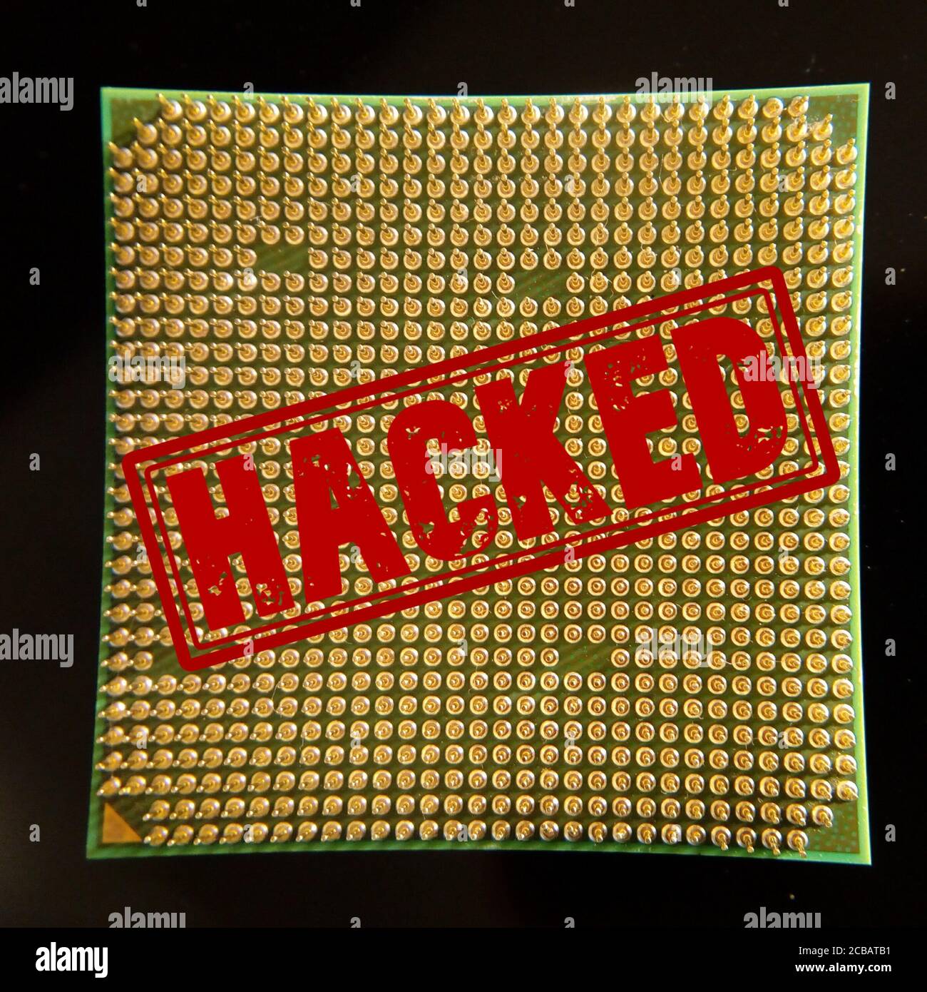 Closeup of a CPU processor with a red "HACKED" stamp - internet ...