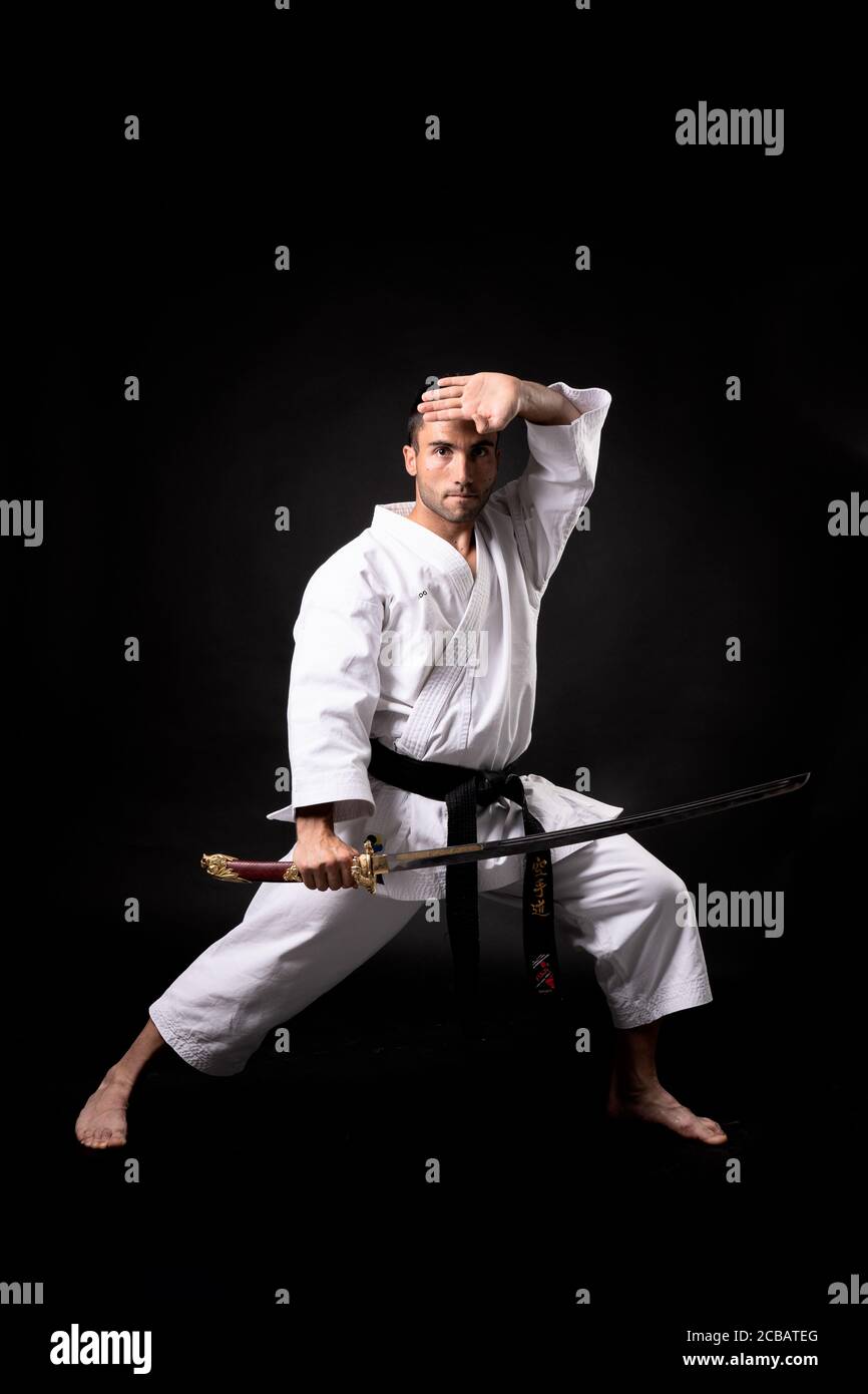 karateka practicing kata with black background Stock Photo - Alamy