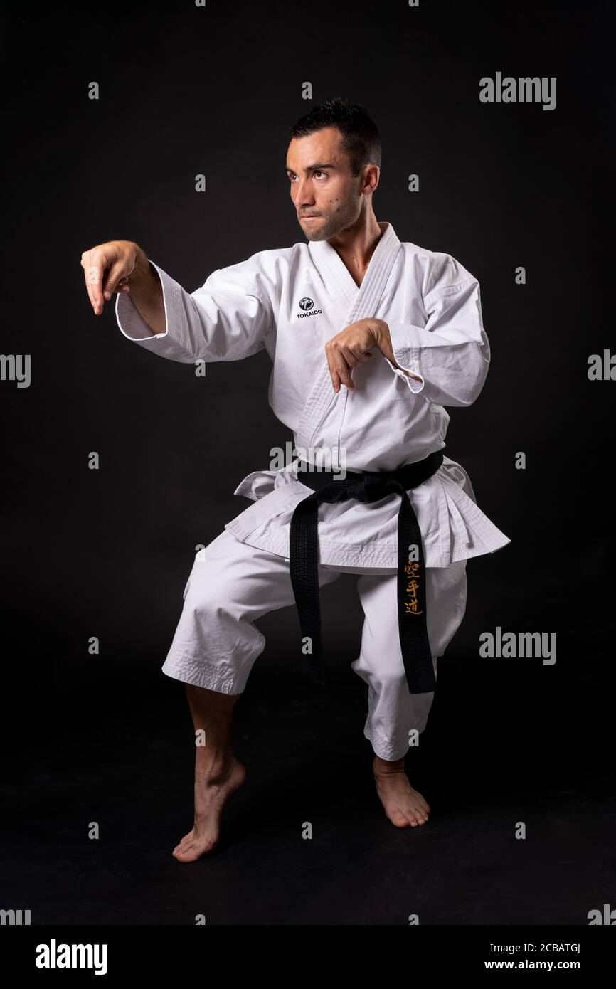 karateka practicing kata with black background Stock Photo - Alamy