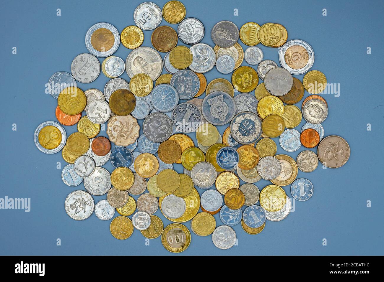 mix of white and yellow coins from different countries Stock Photo - Alamy