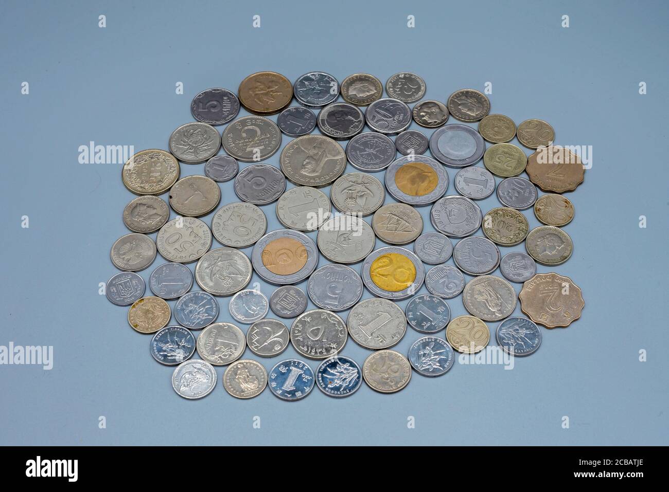 mix of white and yellow coins from different countries Stock Photo - Alamy