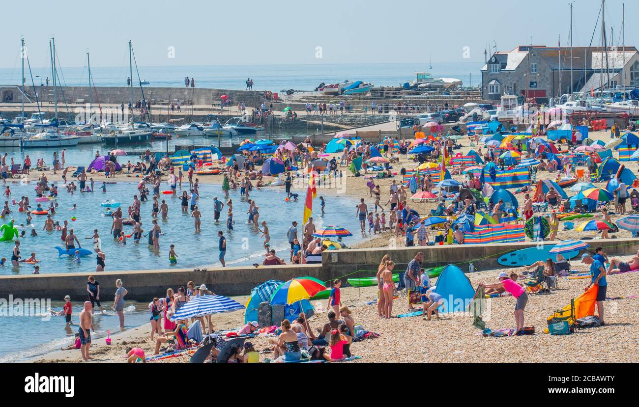 Lyme Regis, Dorset, UK. 12th Aug, 2020. UK Weather: Crowds of ...