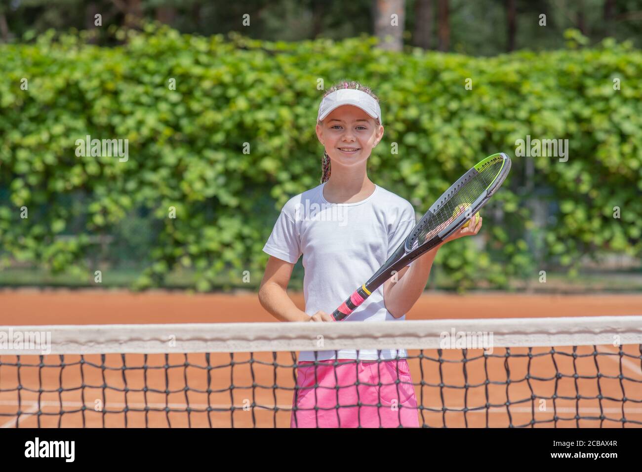 Portrait of a young girl with a tennis racket Stock Photo - Alamy