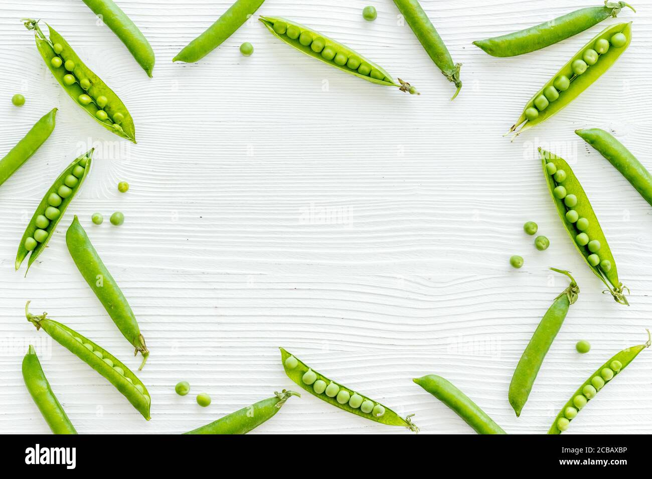 Frame of green pea pods and peas on the kitchen background Stock Photo ...