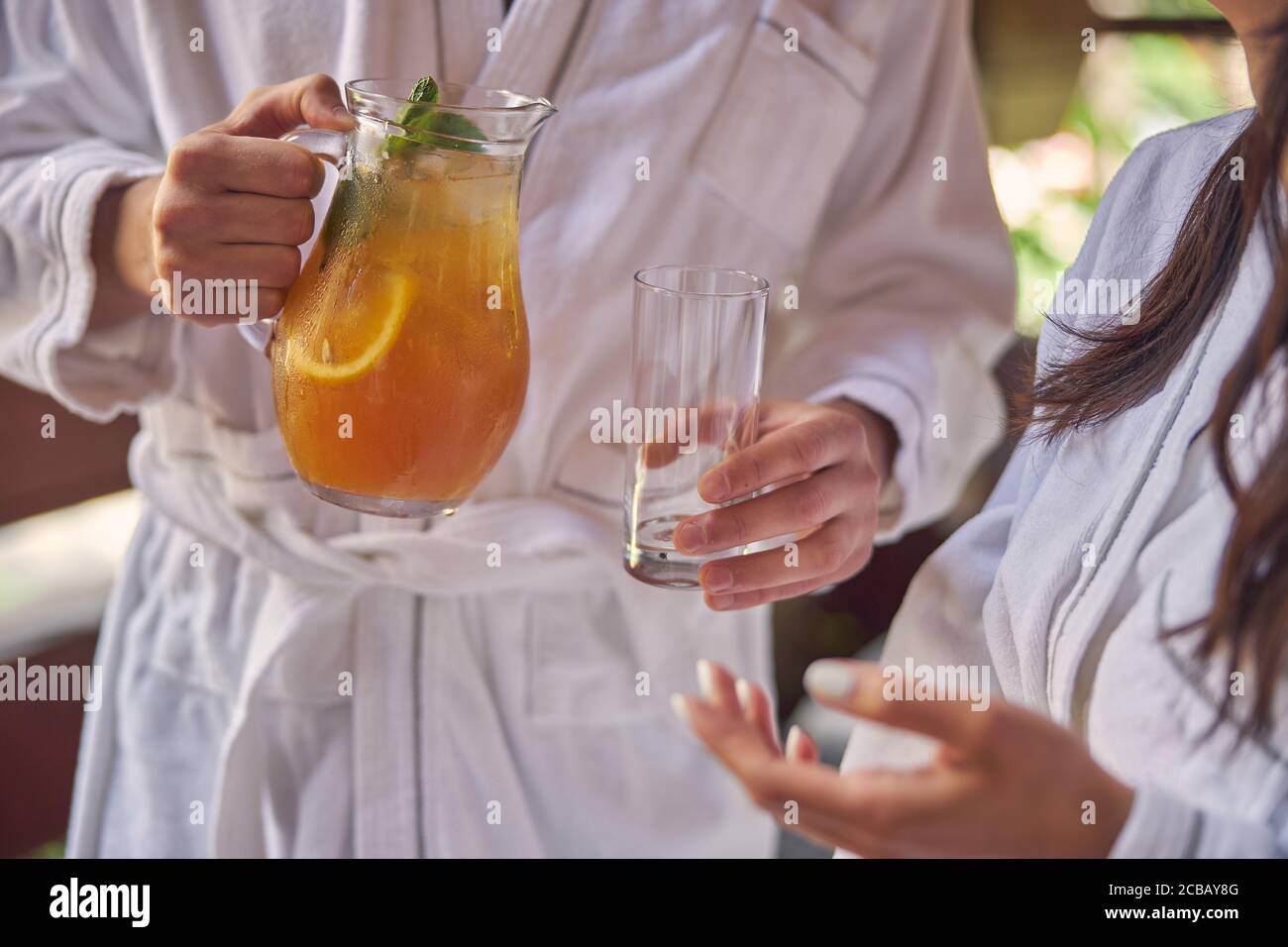 Woman pouring orange lemonade hi-res stock photography and images - Alamy