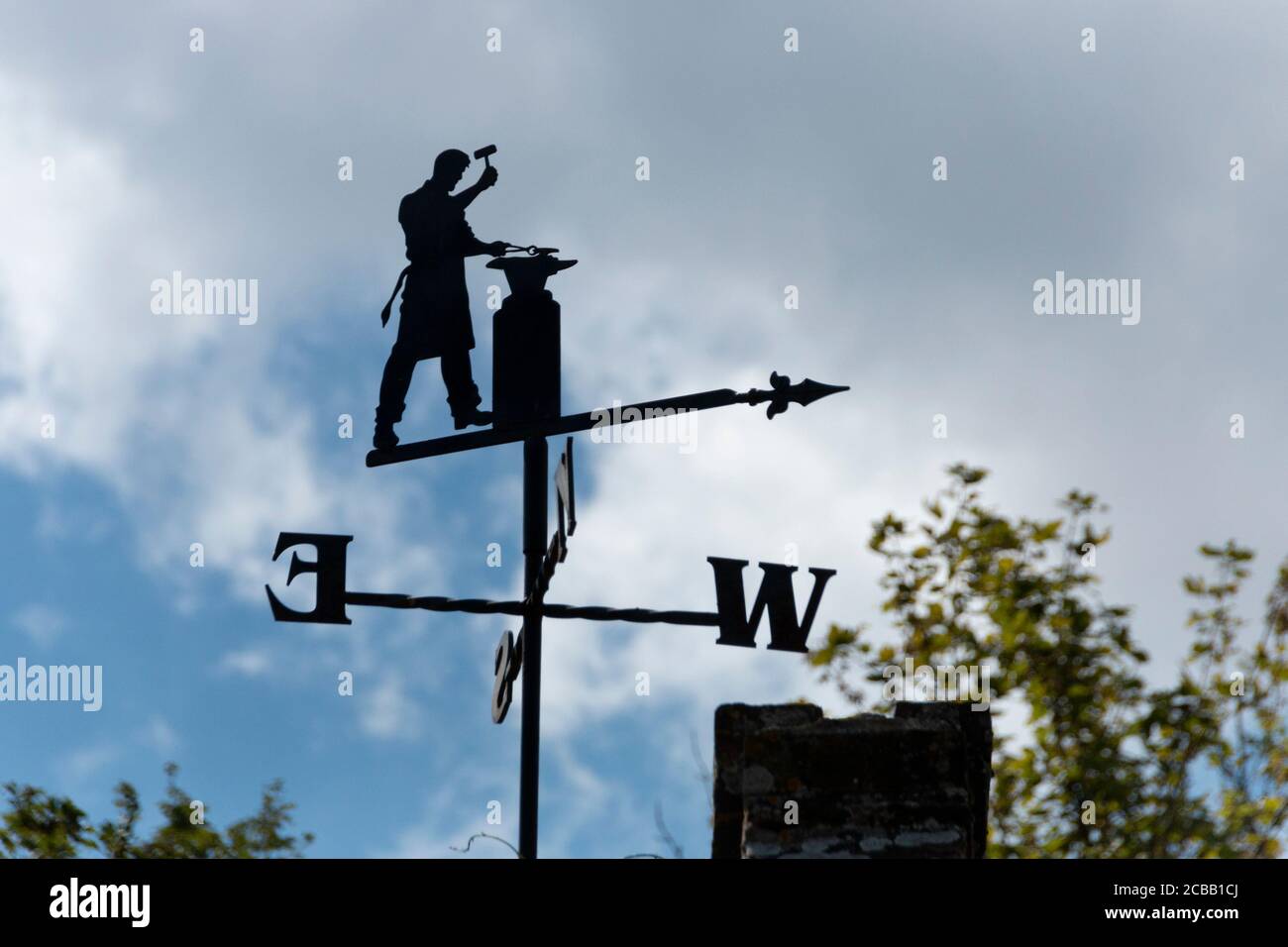 a close up view of a metal wind compass with a blacksmith design on ...