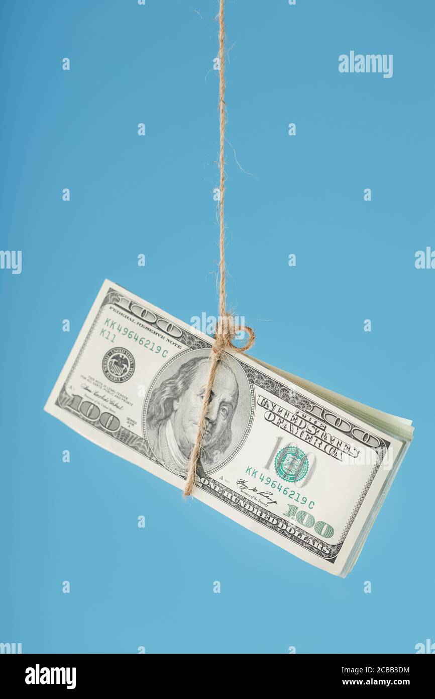 Dollars are tied on a rope, on a blue background. Isolate, free space ...