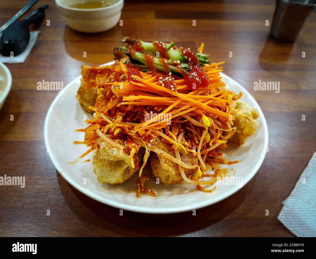 Bibim Mandu, or Bibim Mandoo. Korean style mixed dumplings. Pan fried ...