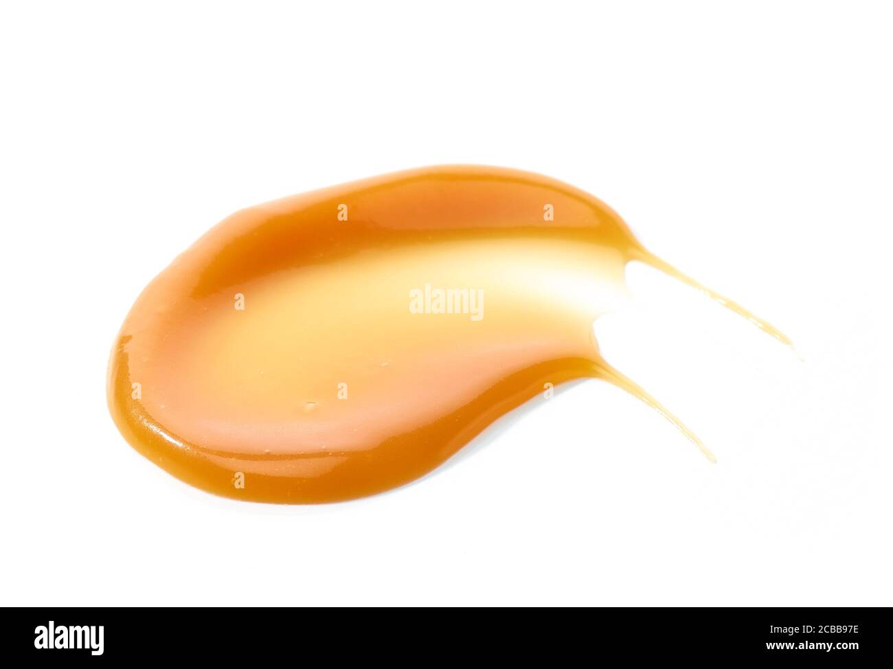melted caramel drop isolated on white background Stock Photo - Alamy