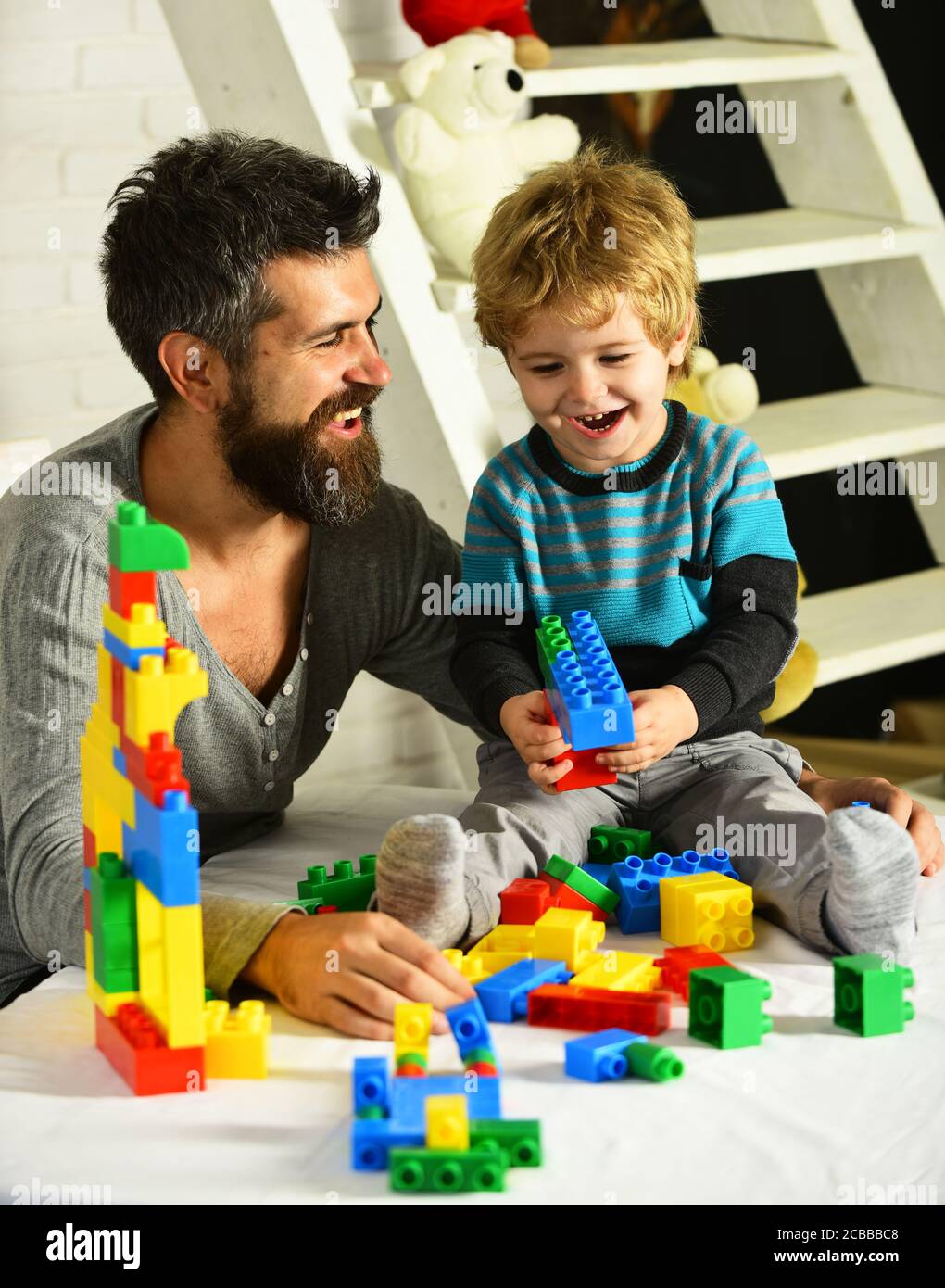 Family and childhood concept. Man and boy play together. Father and son ...