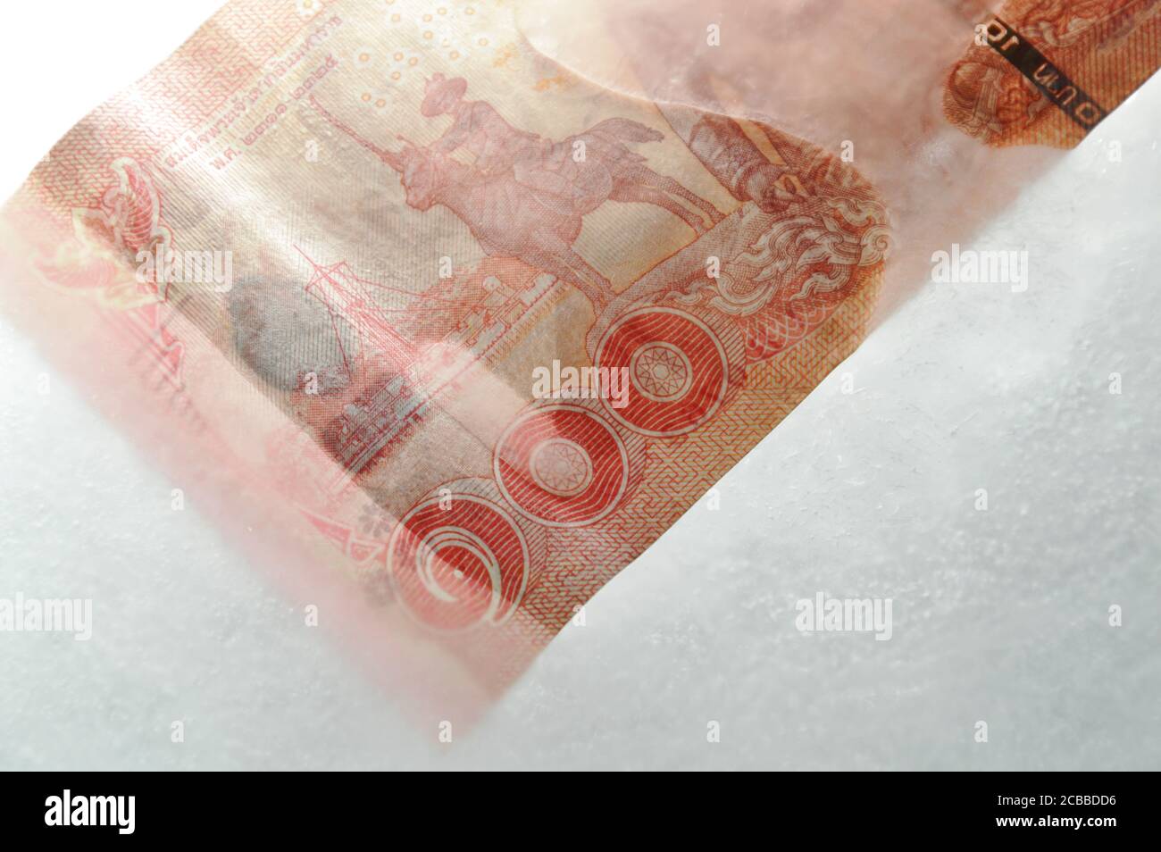 Thai banknote freezing in ice on plastic tray Stock Photo - Alamy