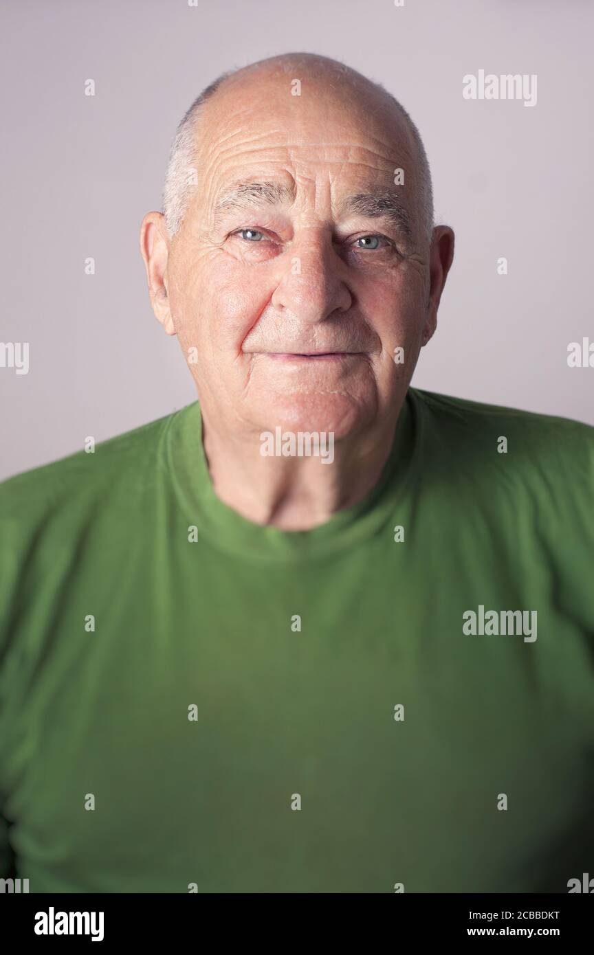 Senior man smiling in studio portrait Stock Photo - Alamy