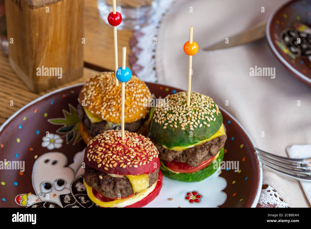 Colorful mini burgers at ceramic plate Stock Photo - Alamy