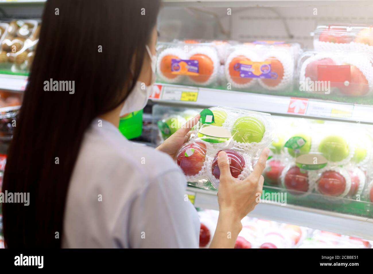 Women long hair wear protective face mask hands holding green and red ...